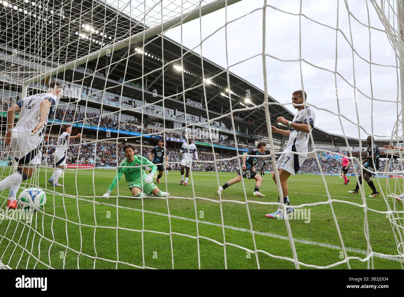 Minnesota United midfielder Will Trapp, center right, turns away after ...