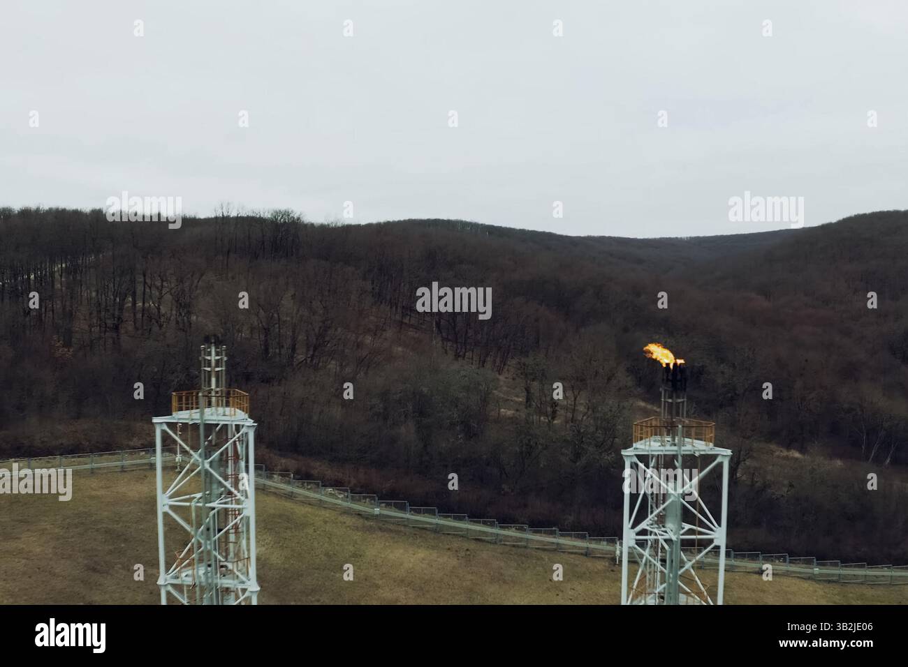 Two torches of the gas combustion system at the gas compressor station ...