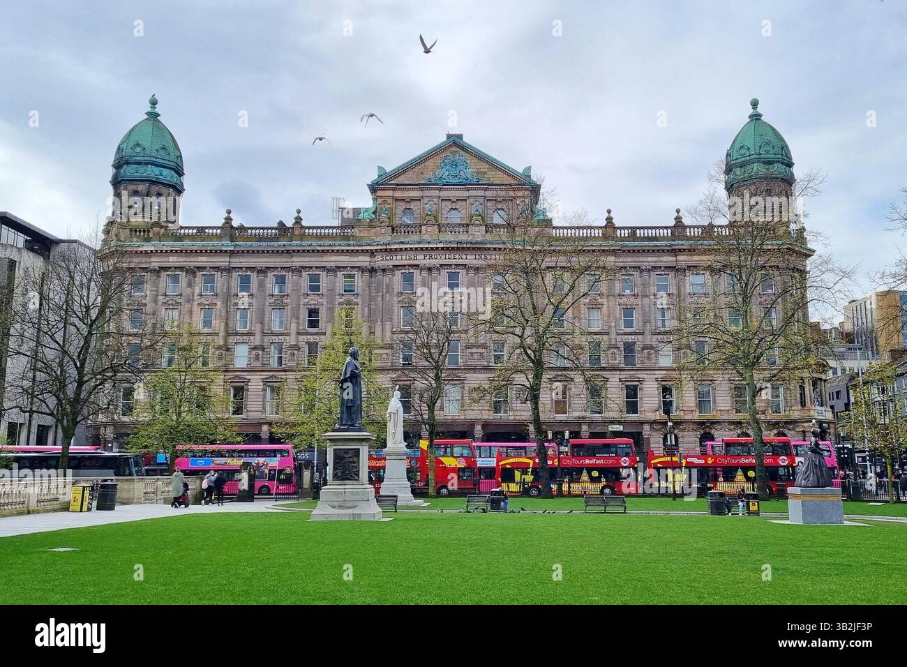View of grand historic commercial Victorian building and red tourist ...