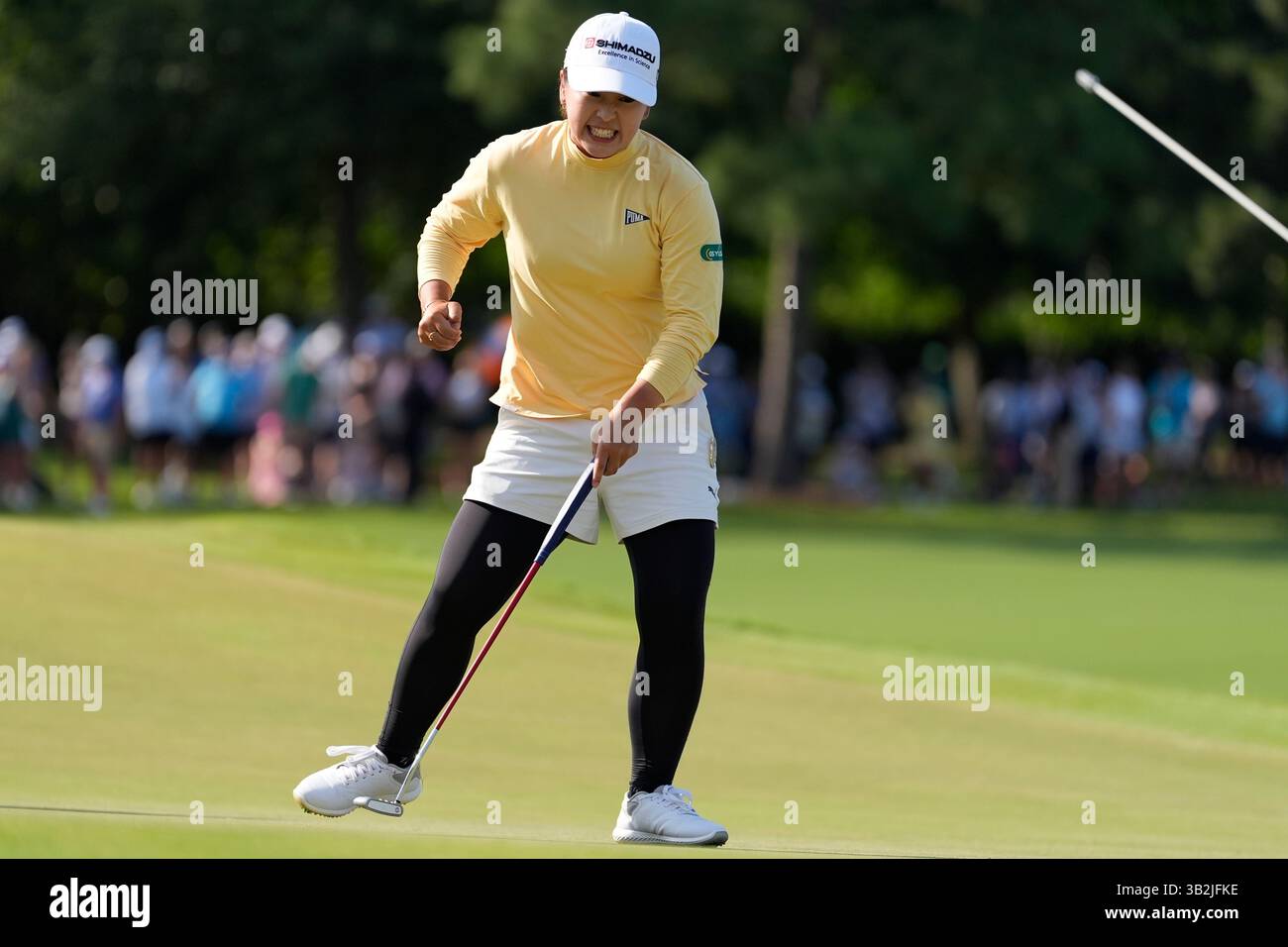 Mao Saigo, of Japan, celebrates her birdie putt on the 18th green ...