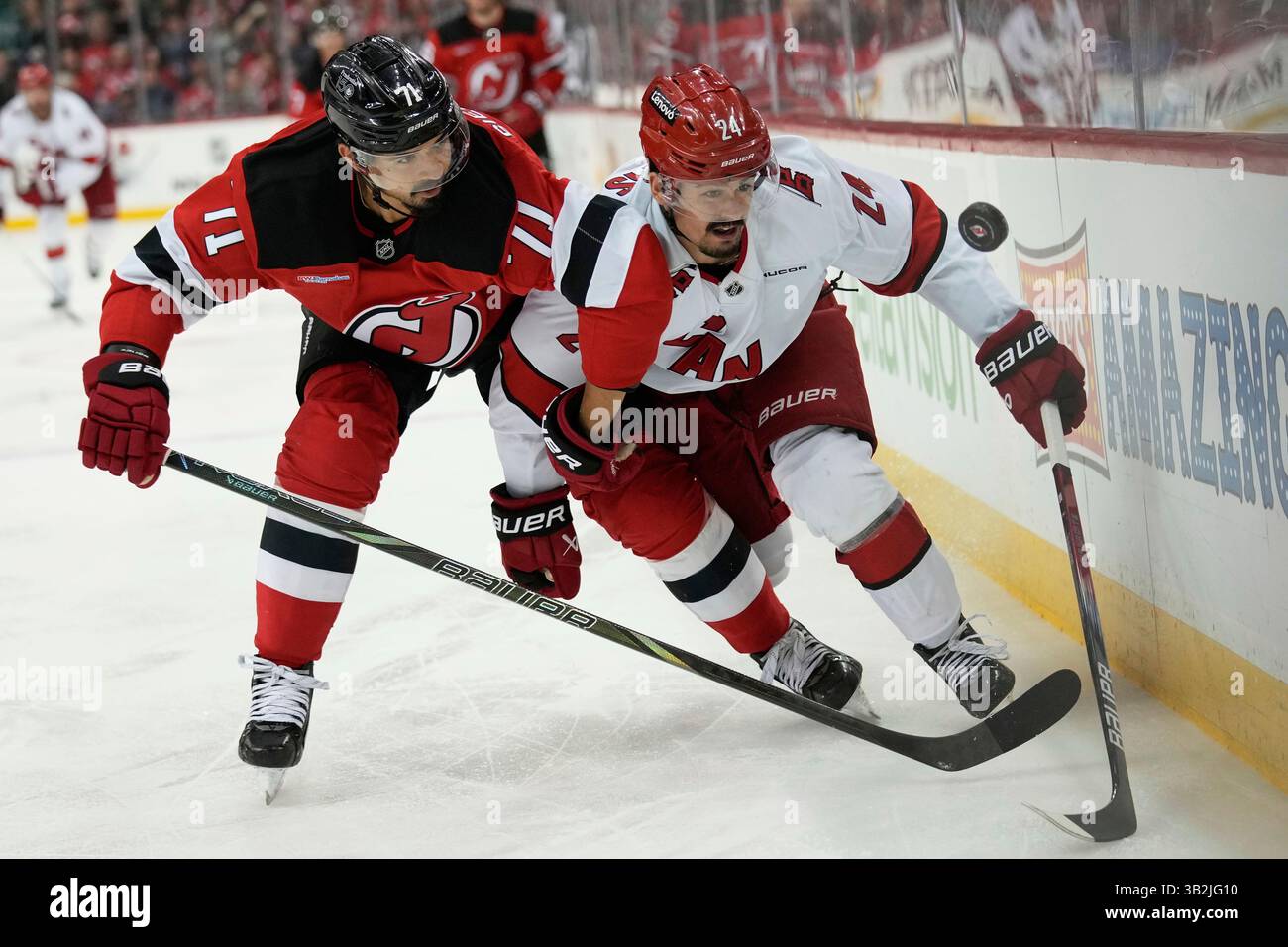 New Jersey Devils' Jonas Siegenthaler, left, and Carolina Hurricanes ...