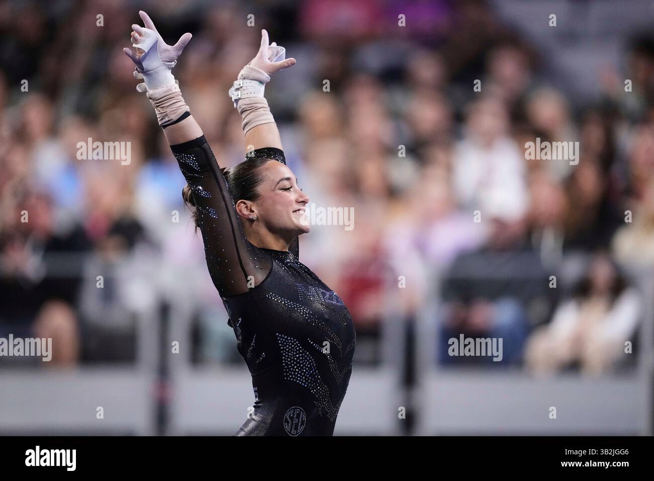 Missouri's Mara Titarsolej competes on the uneven bars during the NCAA ...