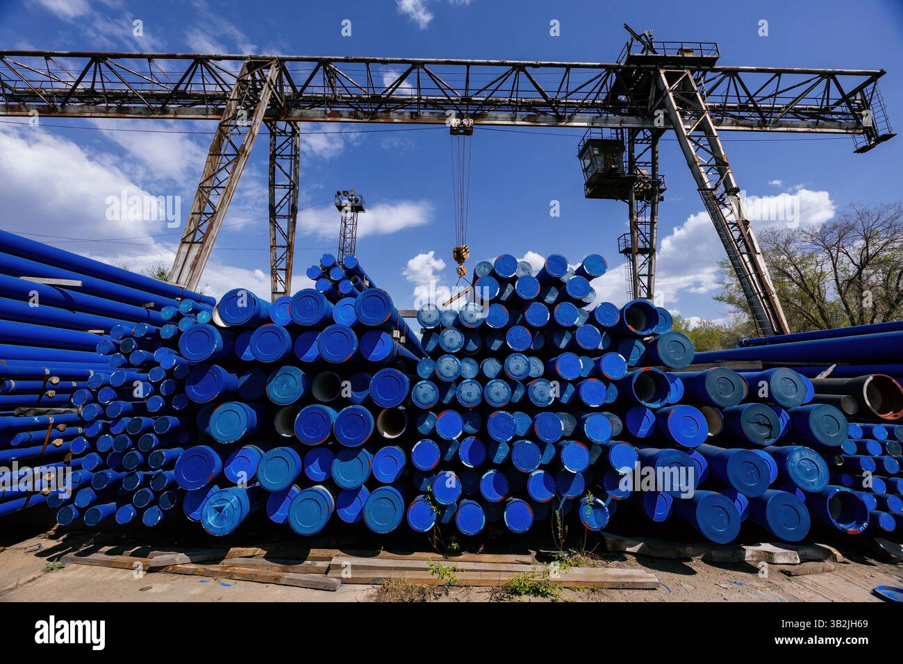 Stack of cast iron pipes in loading area waiting for transportation ...