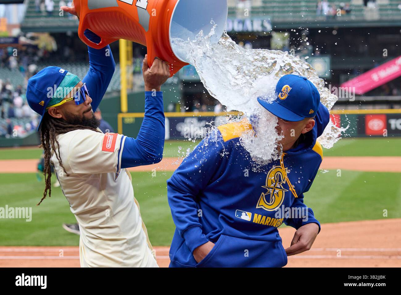 Seattle Mariners starting pitcher Logan Evens, right, is doused by J.P ...