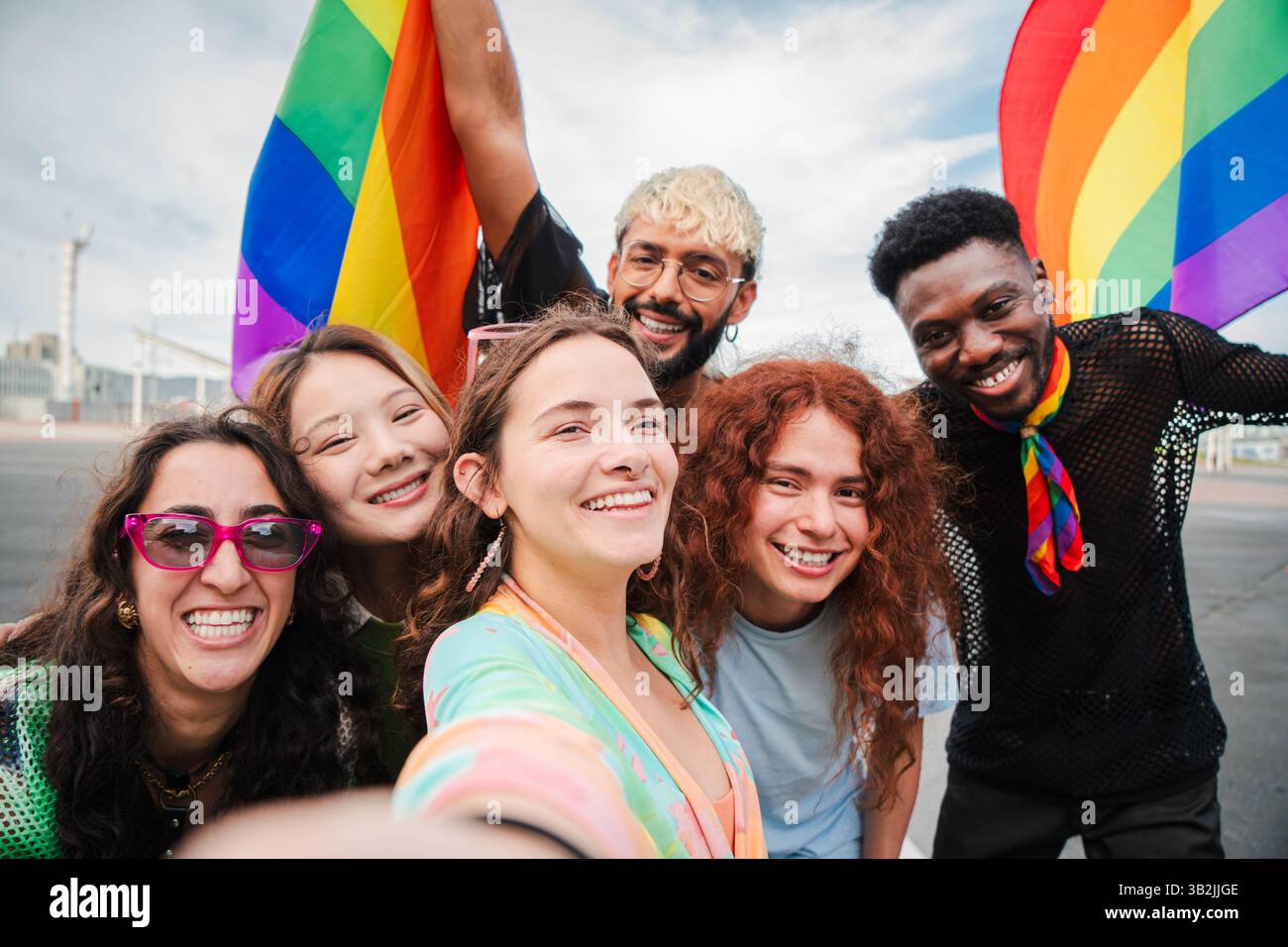 A cheerful and diverse group of friends joyfully celebrating together ...