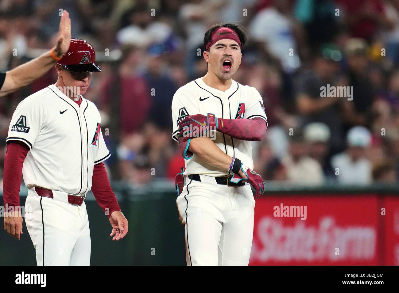 Arizona Diamondbacks' Corbin Carroll, right, shouts after hitting a triple against the Atlanta ...