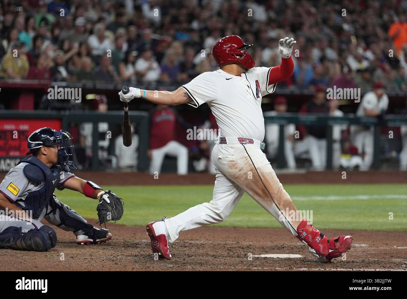Arizona Diamondbacks' Josh Naylor, right, watches the flight of his two ...