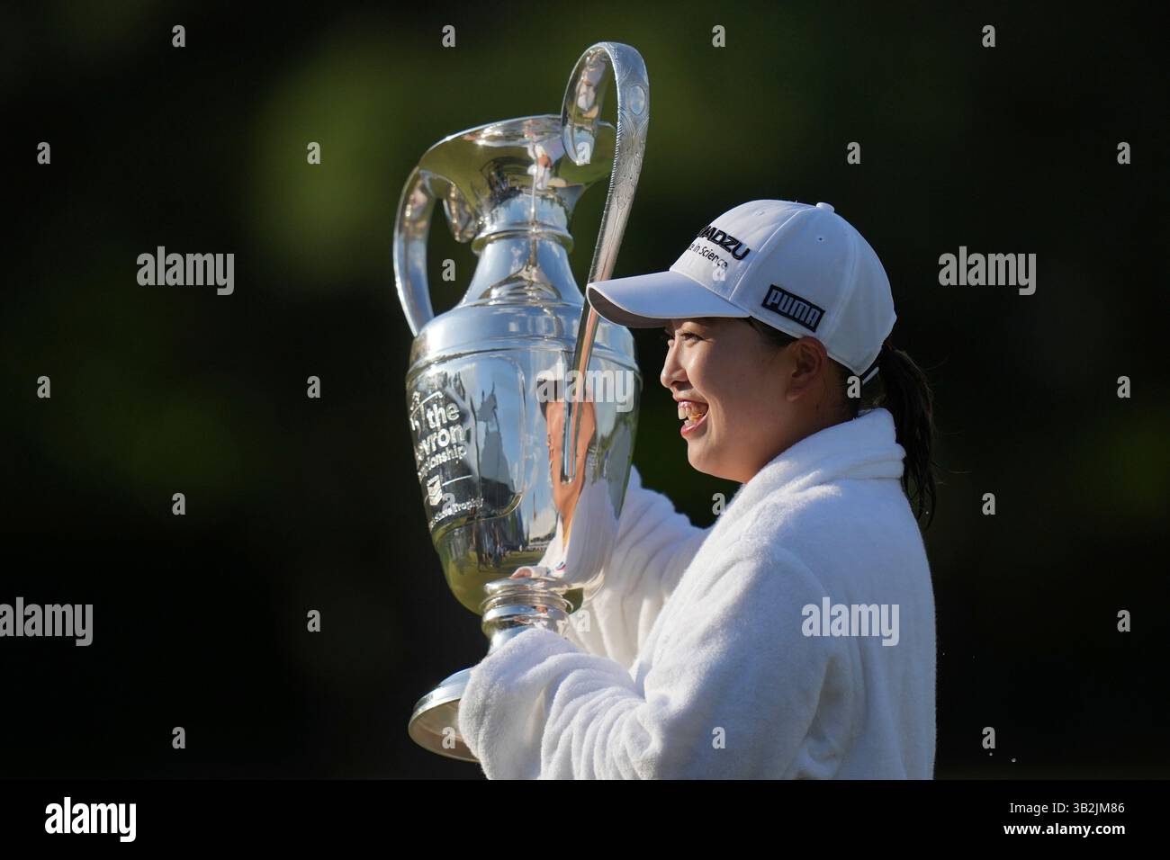 Mao Saigo, of Japan, holds the trophy after winning the Chevron ...