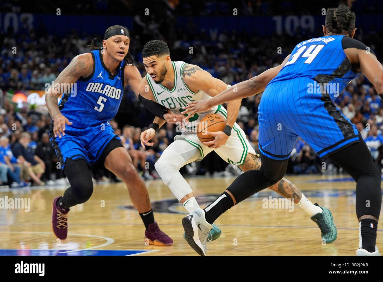 Boston Celtics forward Jayson Tatum, center, drives between Orlando ...