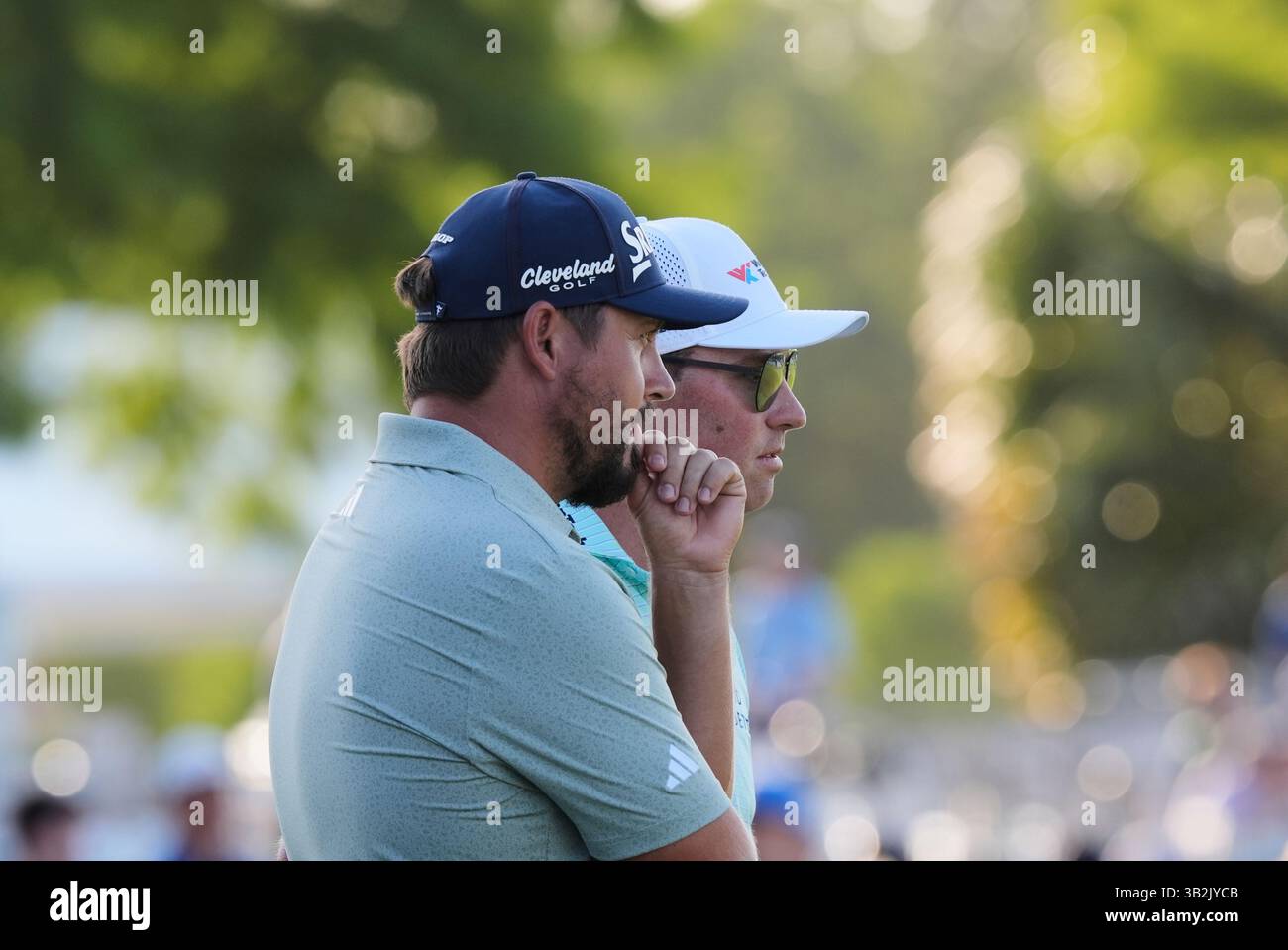 Andrew Novak, left, and teammate Ben Griffin talk on the 17th green ...