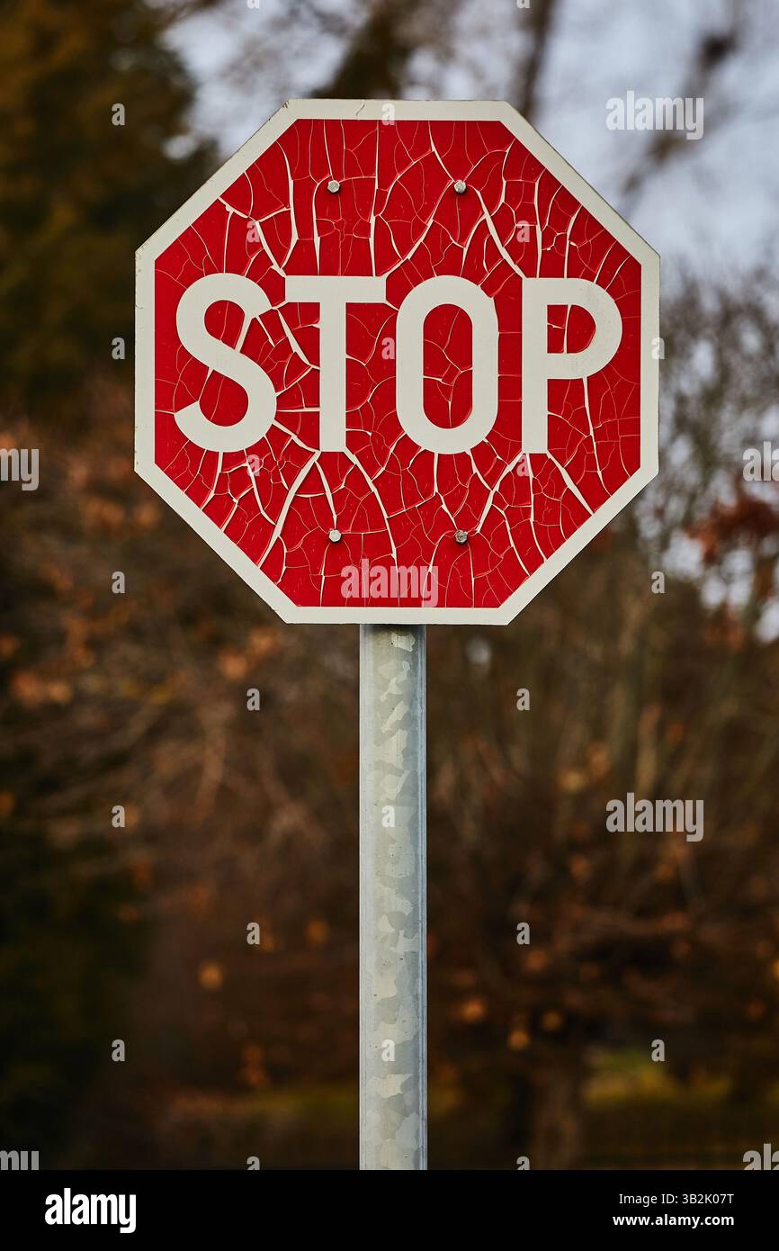 Stop sign with broken paint peeling Stock Photo - Alamy
