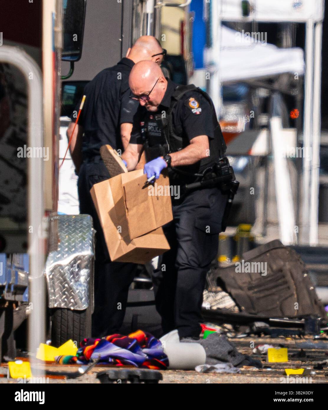 Members of the Vancouver Police forensics team collects a victim's shoe ...