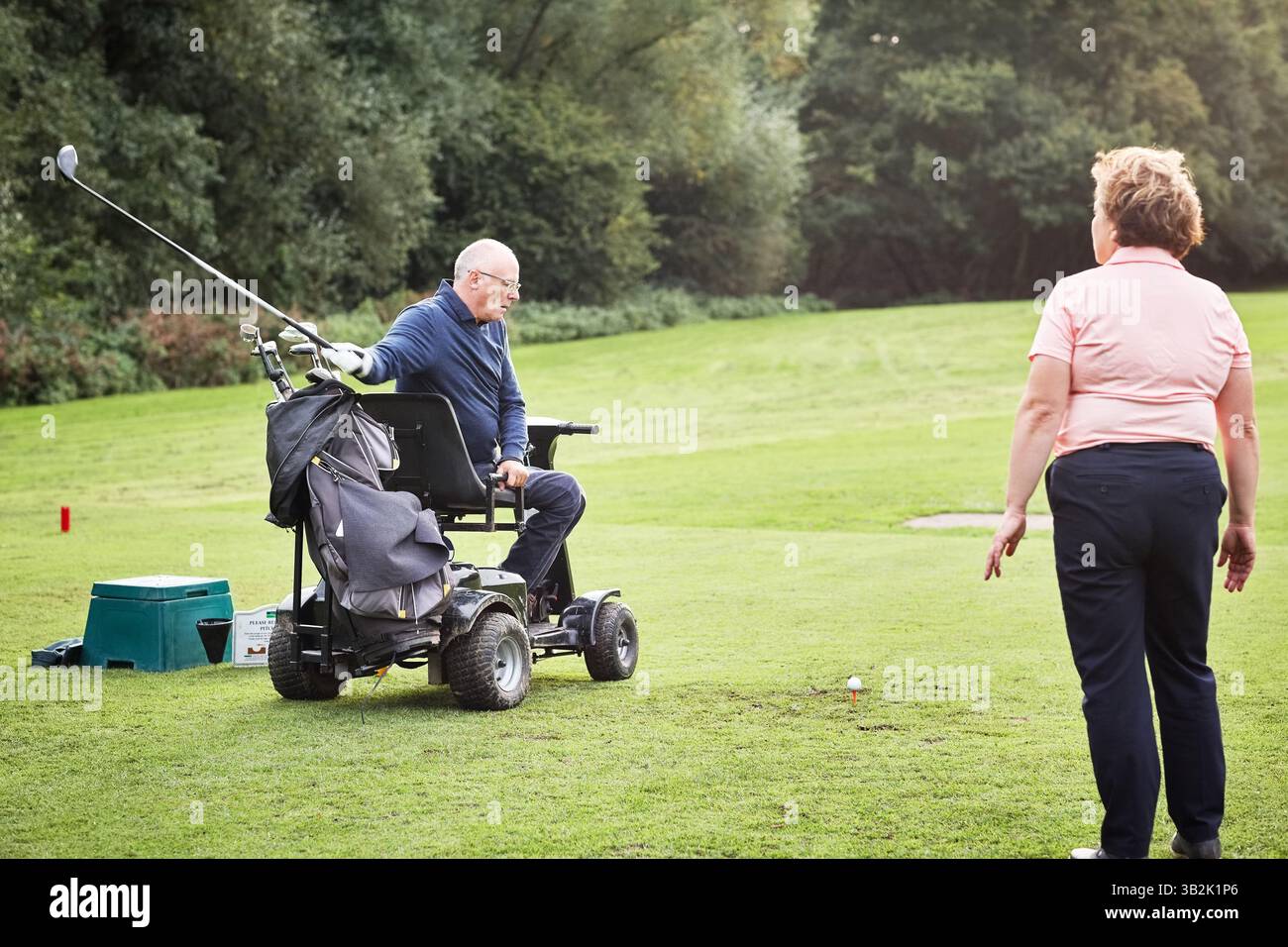 Sports, person with disability and trainer for golf game, match and competition on golfing ...
