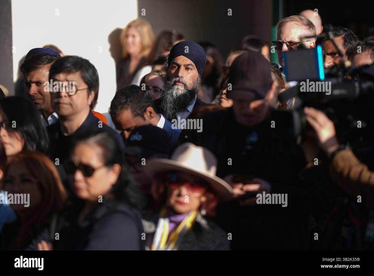 NDP Leader Jagmeet Singh stands in the crowd while listening to ...