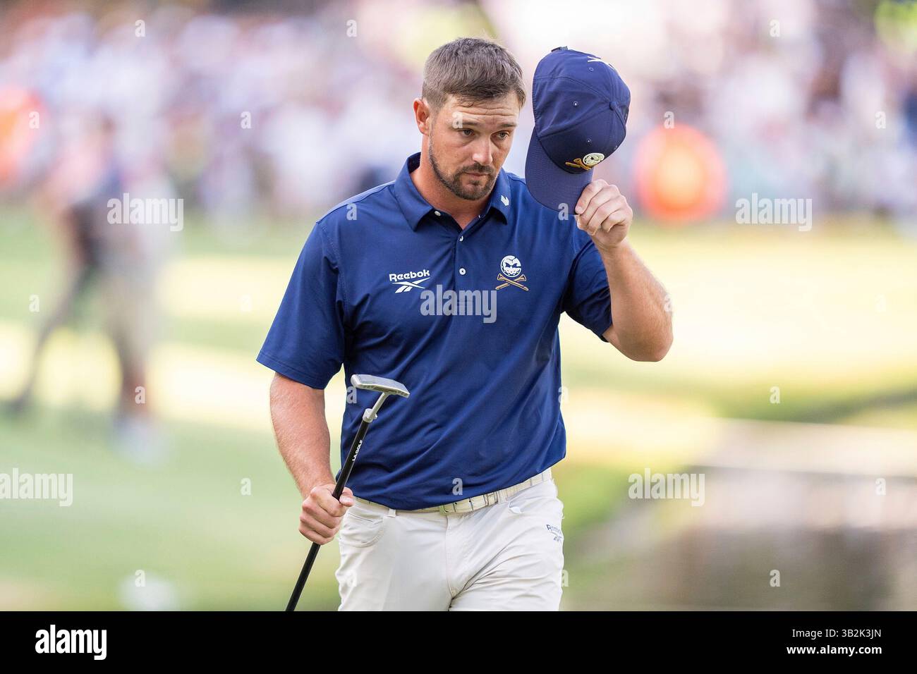 Captain Bryson DeChambeau of Crushers GC tips his cap on the 18th green after the final round of ...