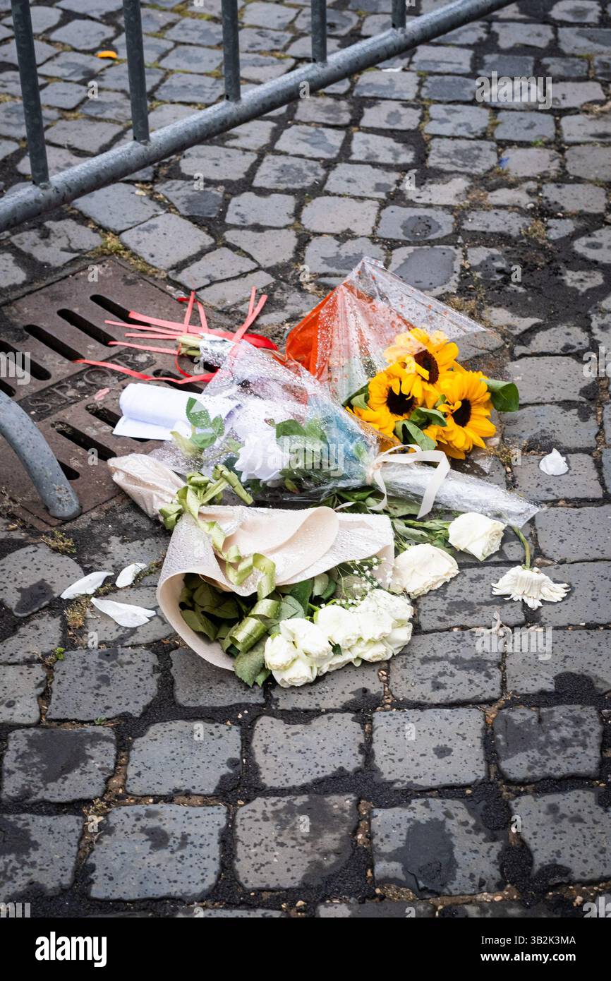 Flowers for Pope Francis left by parishioners at the gates of the ...