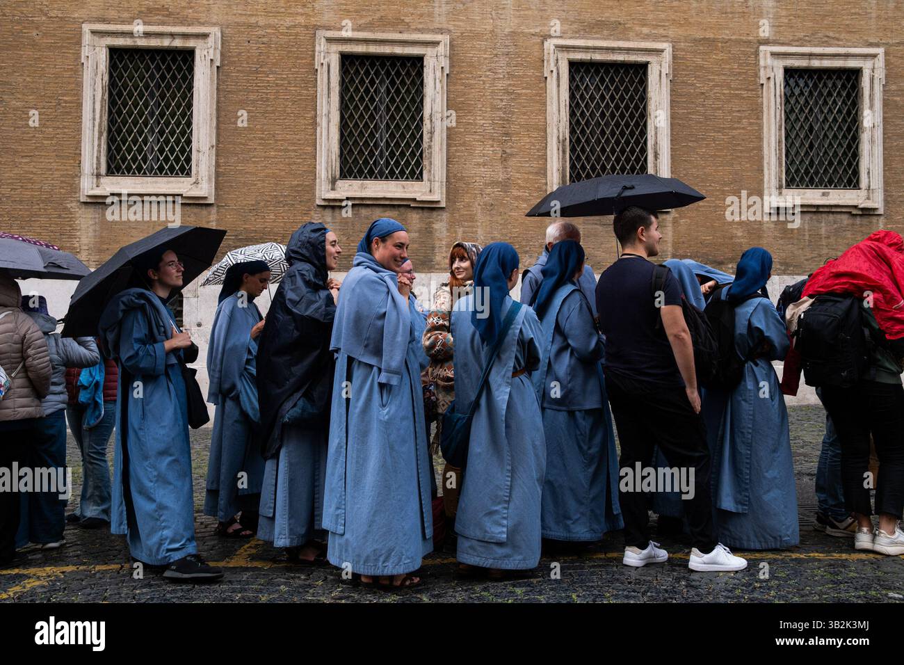 Nuns wait in line to visit the tomb of Pope Francis at the Basilica of ...