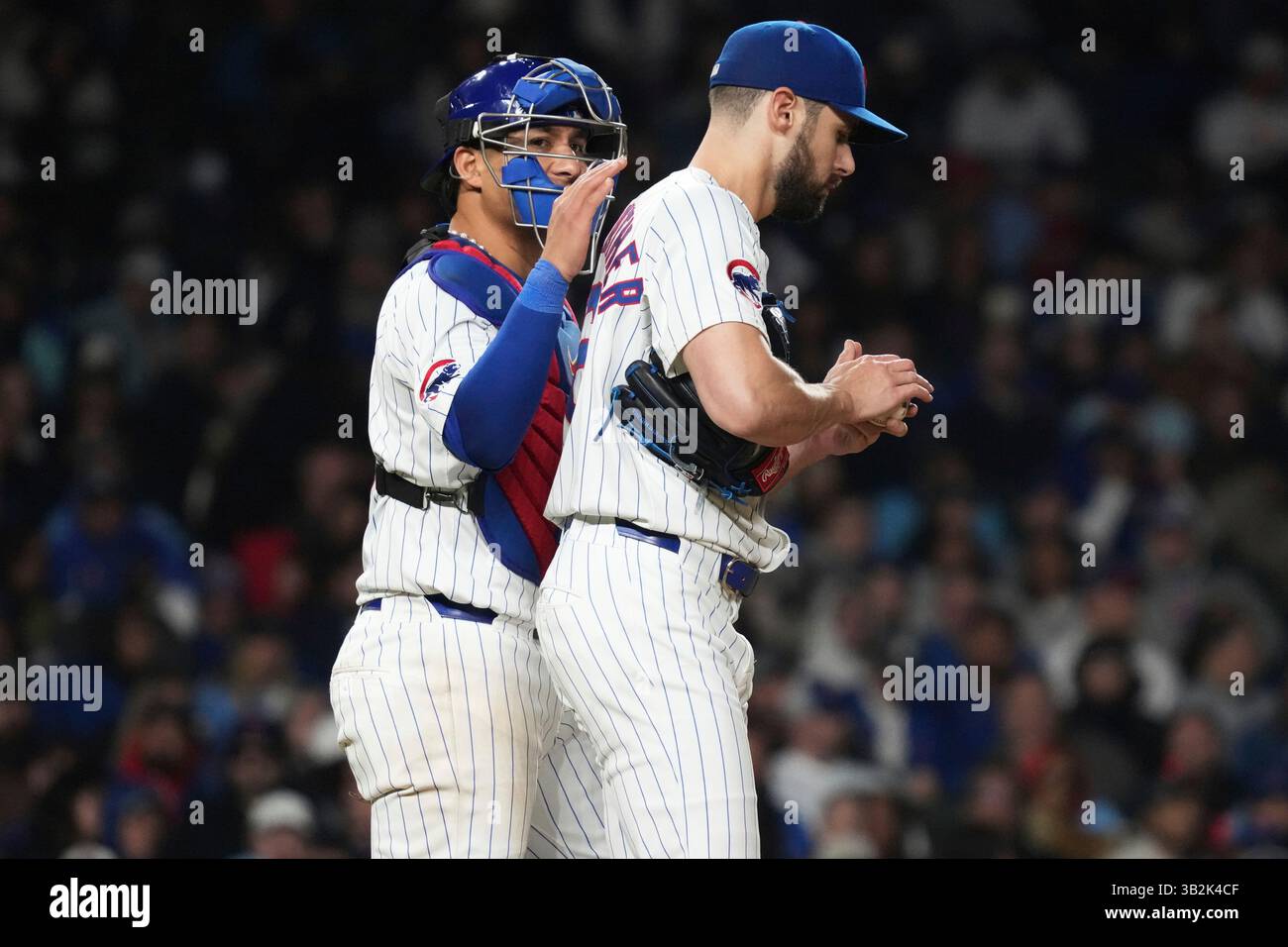 Chicago Cubs catcher Miguel Amaya, left, talks to relief pitcher Julian ...