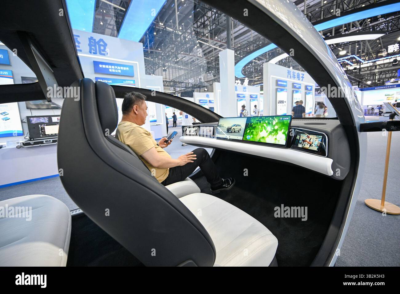 A visitor tries a smart car cabin developed by Chinese carmaker Chery ...