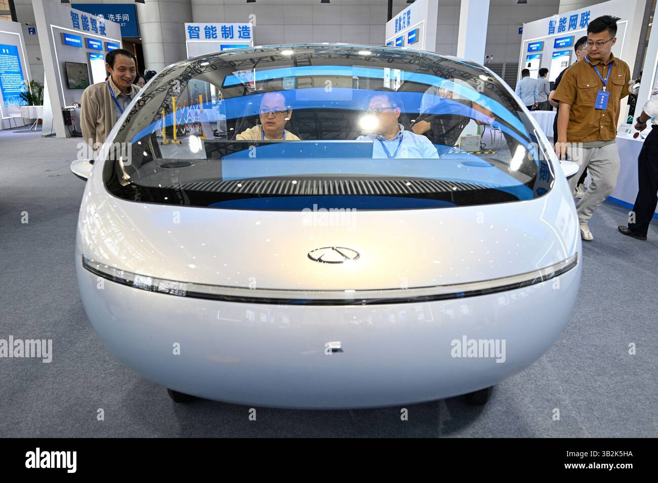 Visitors check out a smart car cabin developed by Chinese carmaker ...