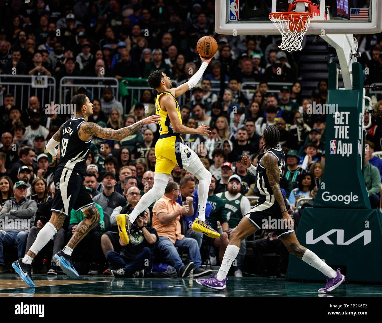 Indiana Pacers' Tyrese Haliburton, middle, puts up a shot against the ...