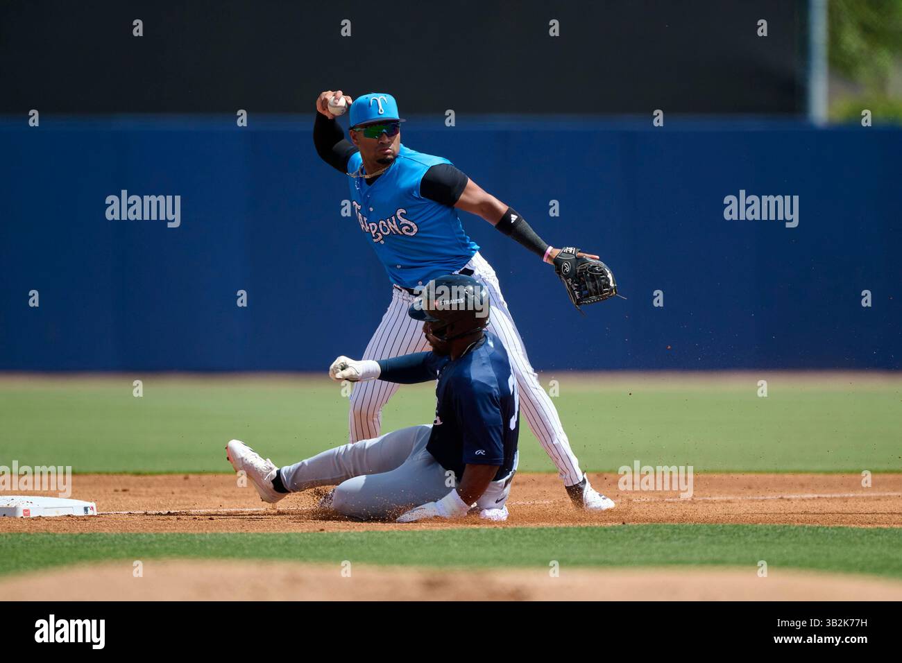 Tampa Tarpons shortstop Roderick Arias (7) turns a double play as Akil ...