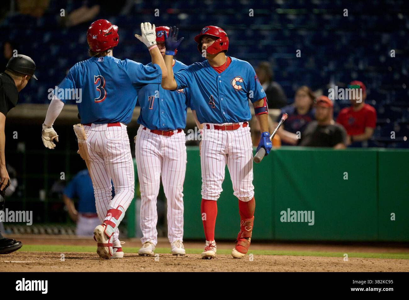 Clearwater Threshers Carter Mathison (3) high fives Raider Tello (4 ...