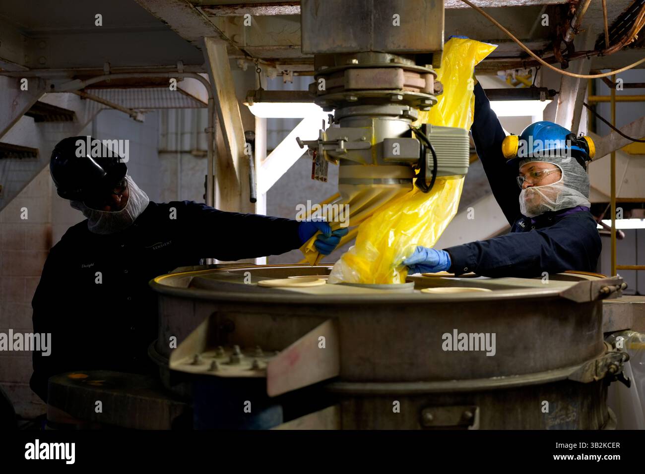 Jobe Washington, right, and Dwight Brown use a large sifter to mix a ...