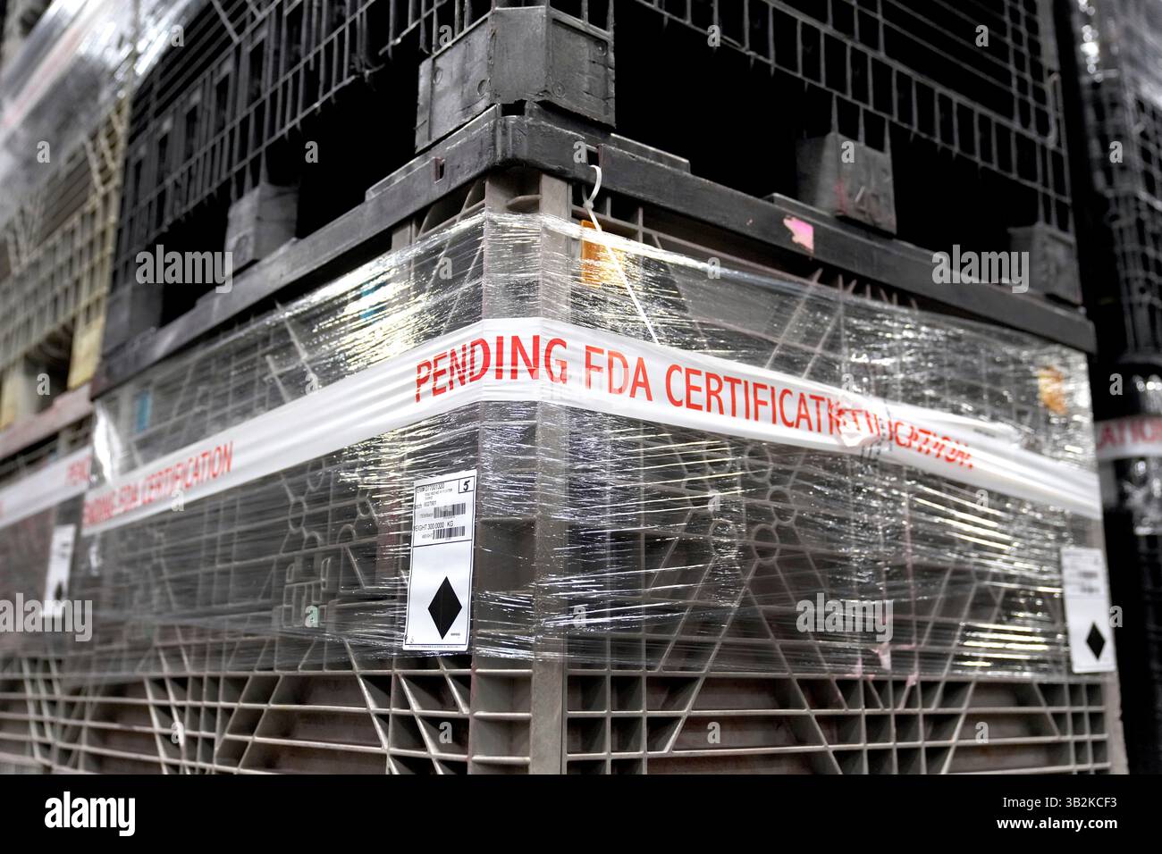 Containers of material wait in a warehouse for certification by the ...