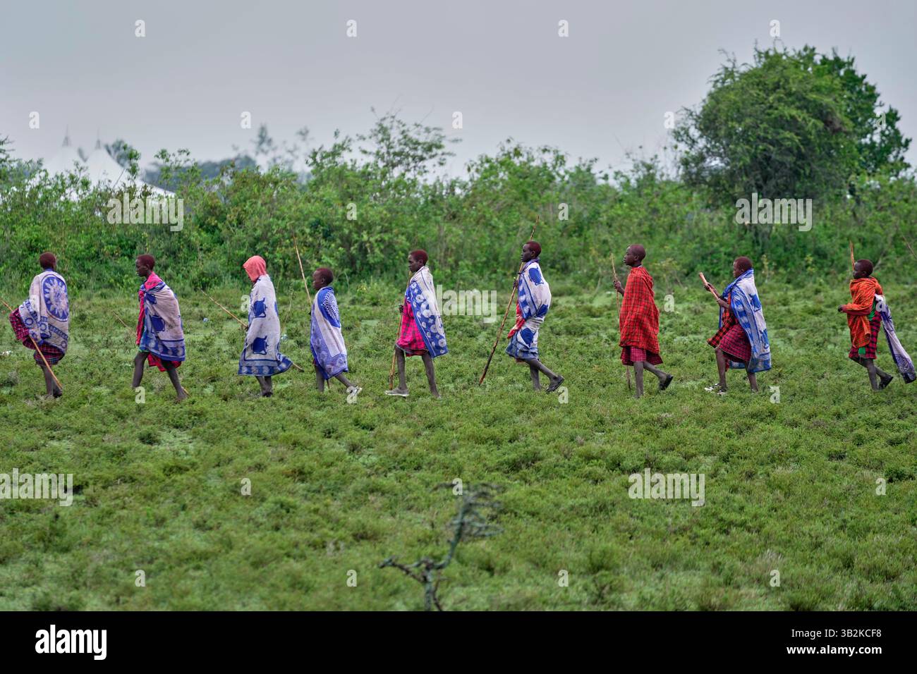 Children of the Maasai tribe walk around an open field, during the ...