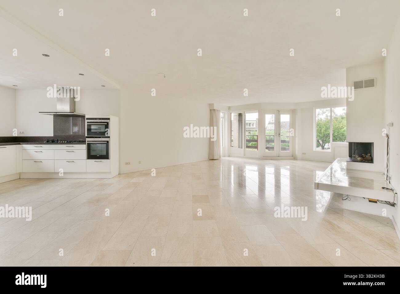 Spacious and bright modern interior featuring sleek cabinetry, serene ...