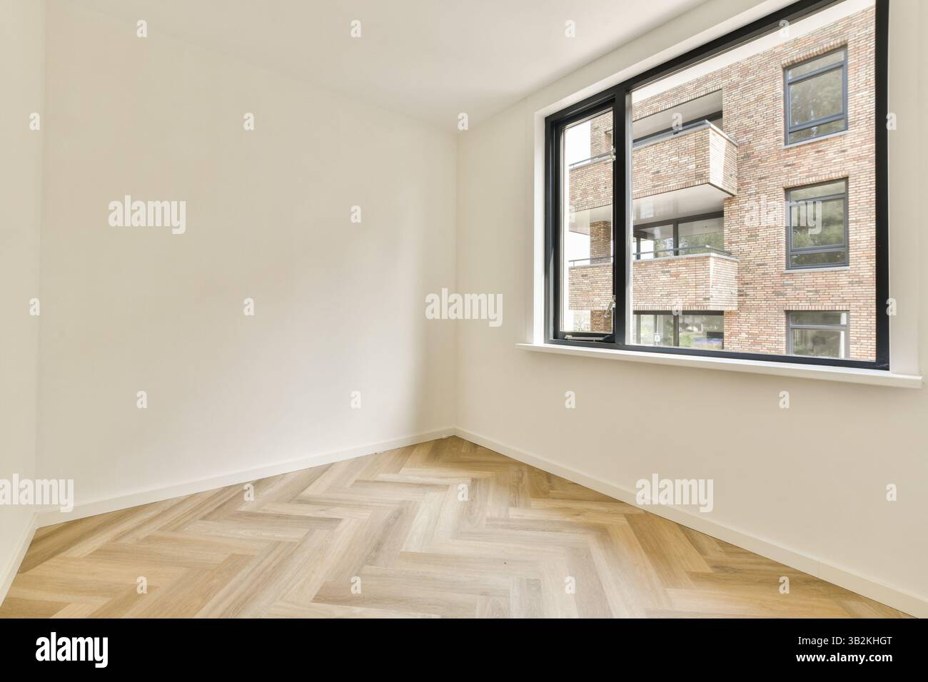 A sleek, modern room featuring a distinctive angular window with a view ...