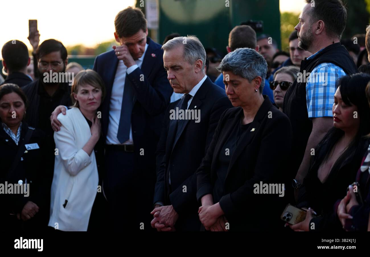 Liberal Leader Mark Carney, center, stands with members of the Filipino ...