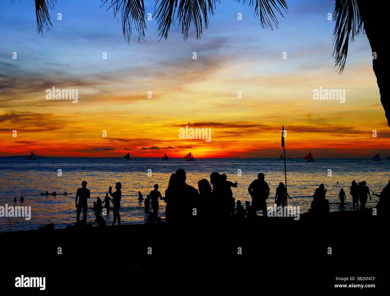 Vacationers enjoy the scenic sunset and tranquil waters at Boracay ...