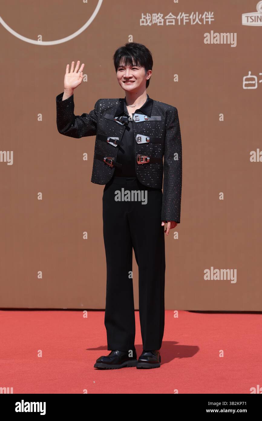 Chinese singer Zhou Shen poses on the red carpet at the 20th Huabiao ...