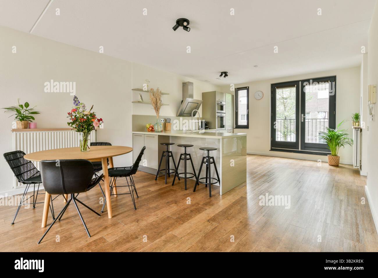 A contemporary kitchen featuring an open layout with a dining area ...