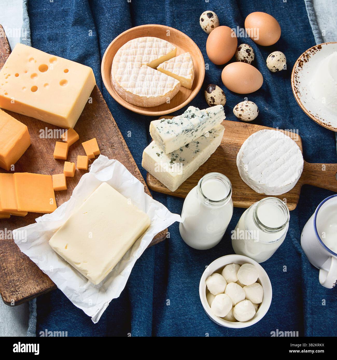 Different types of dairy products - cheese, milk, butter, eggs on a ...