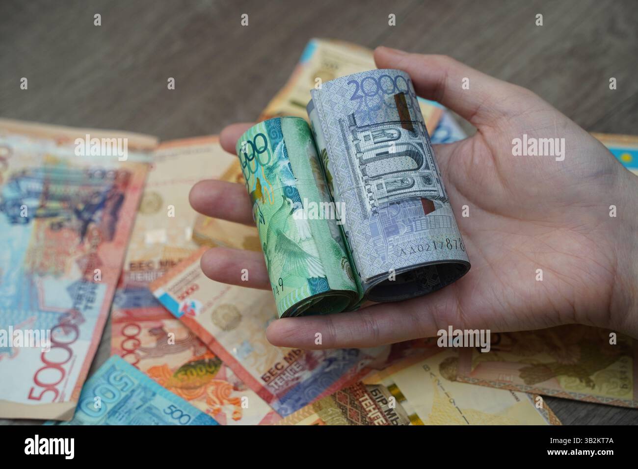 Tenge banknotes of different denominations in the hands Stock Photo - Alamy