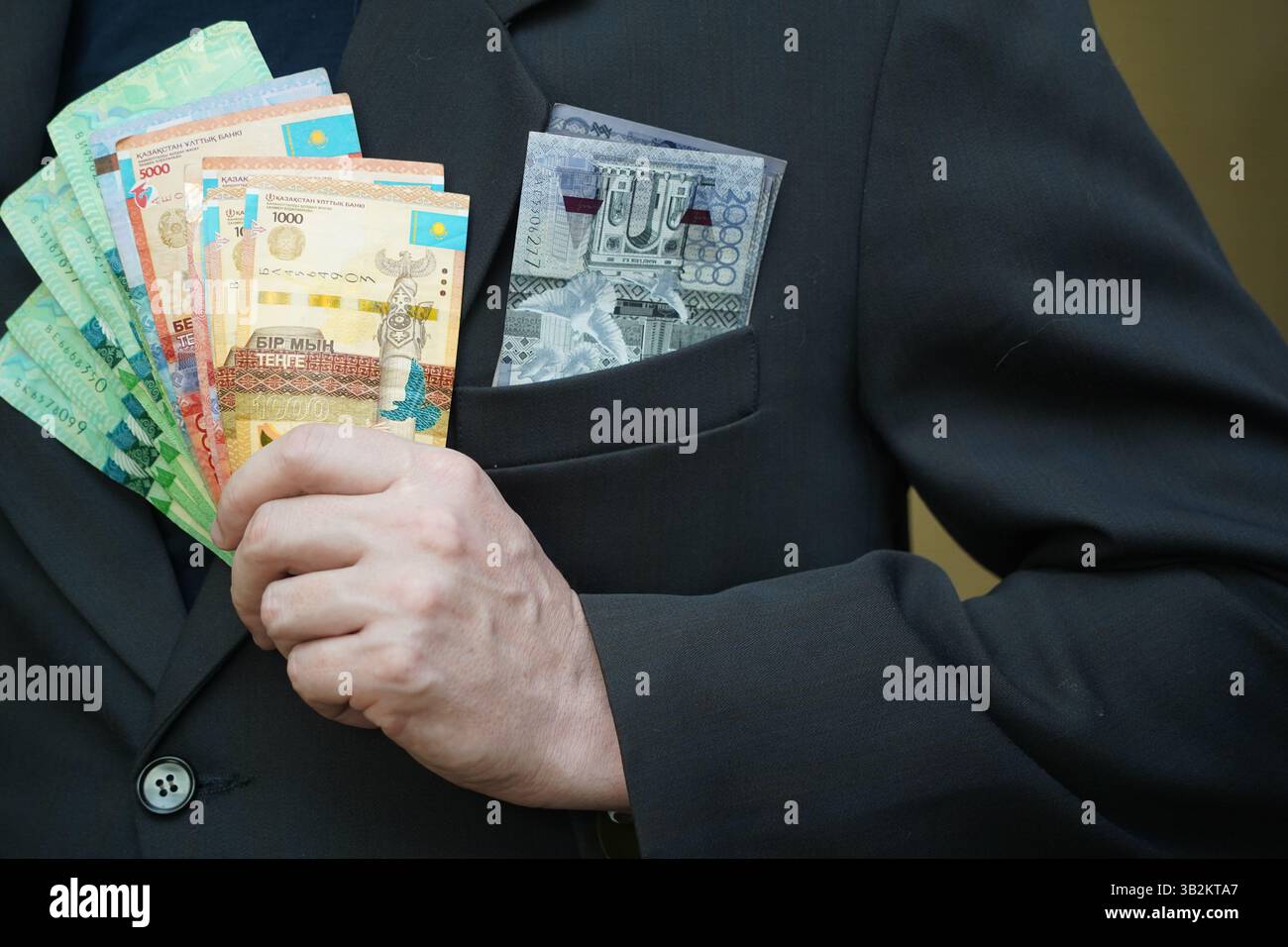 Tenge banknotes of different denominations in the hands Stock Photo - Alamy