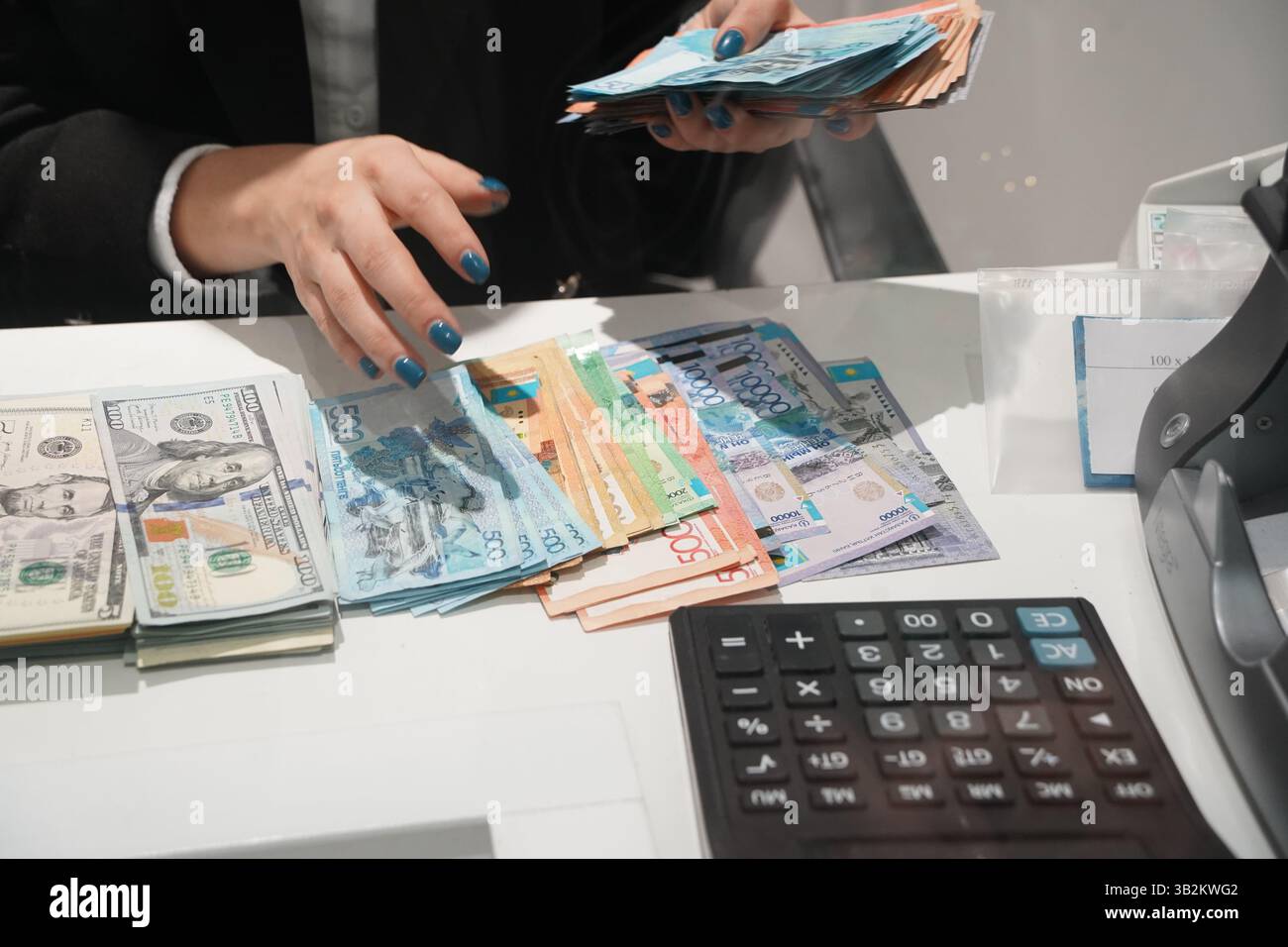 The bank's cash register. Recalculation of banknotes of different ...