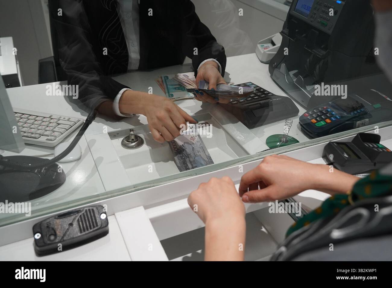 The bank's cash register. Recalculation of banknotes of different ...