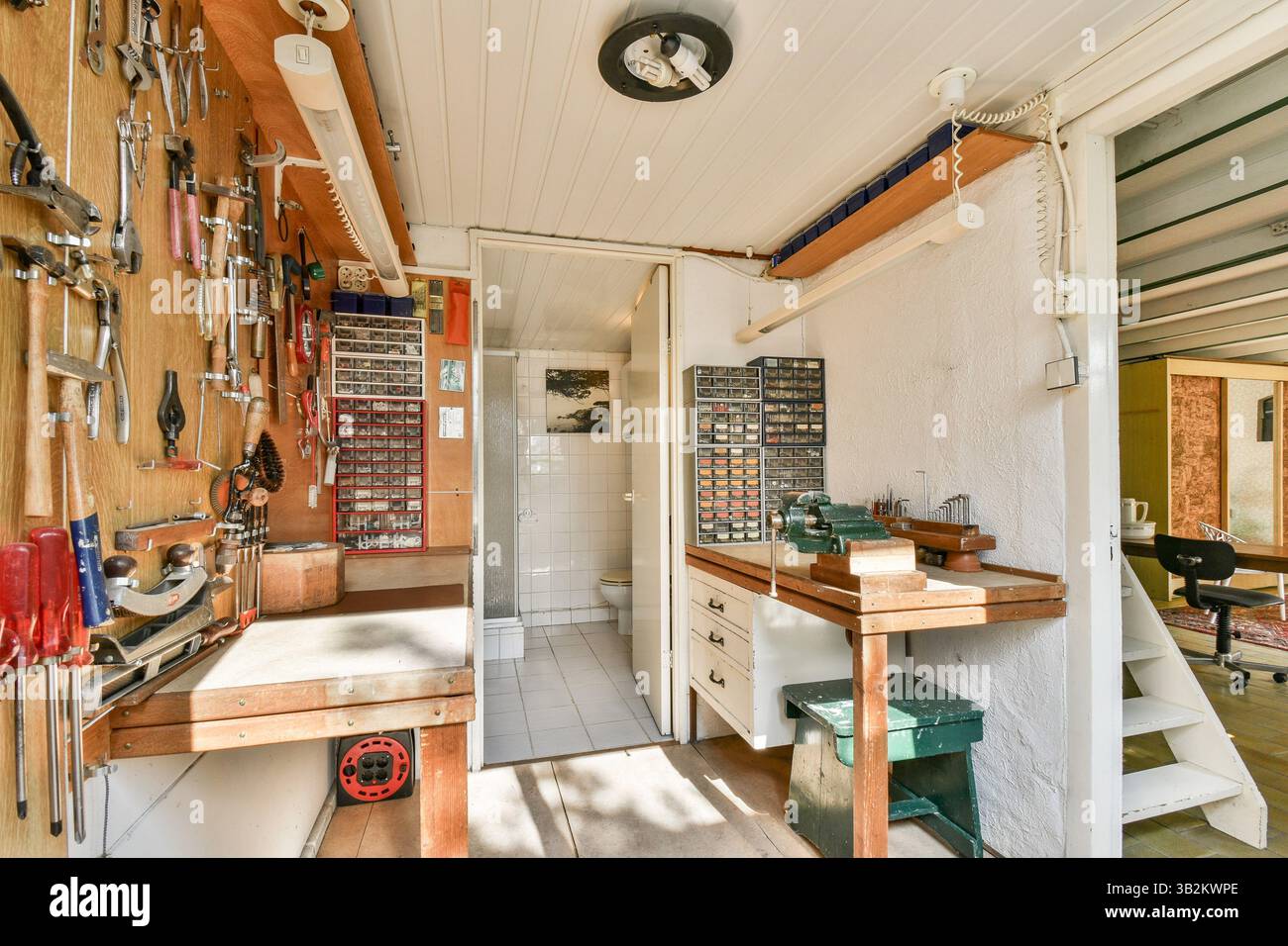 A functional workshop showcasing various hand tools, storage solutions ...