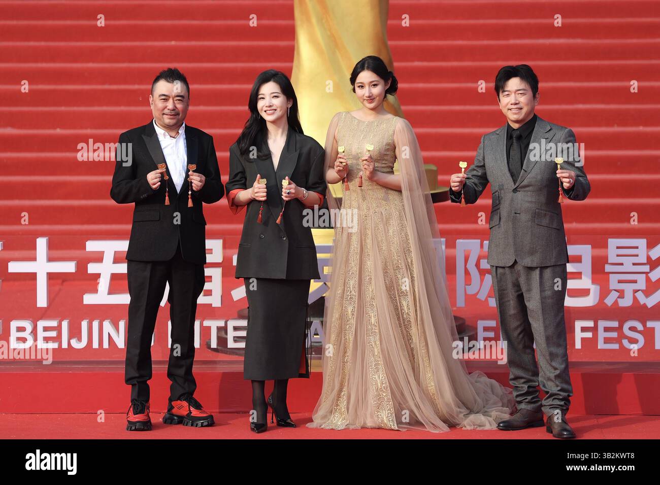 The crew and cast of the film Deep in the Mountains pose on the red carpet. Beijing,China.26th ...