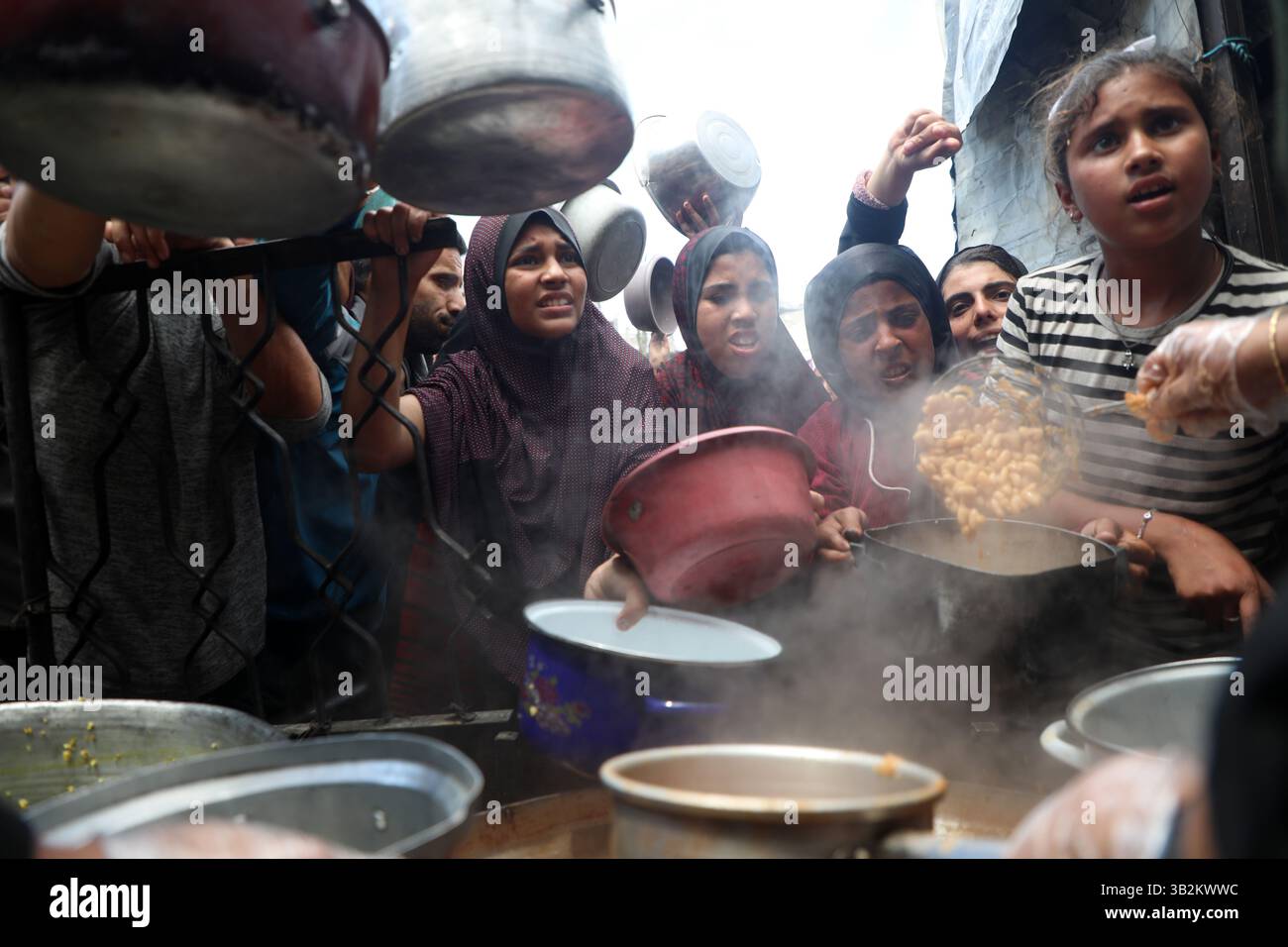 Gaza. 27th Apr, 2025. Palestinians receive free food from a food ...