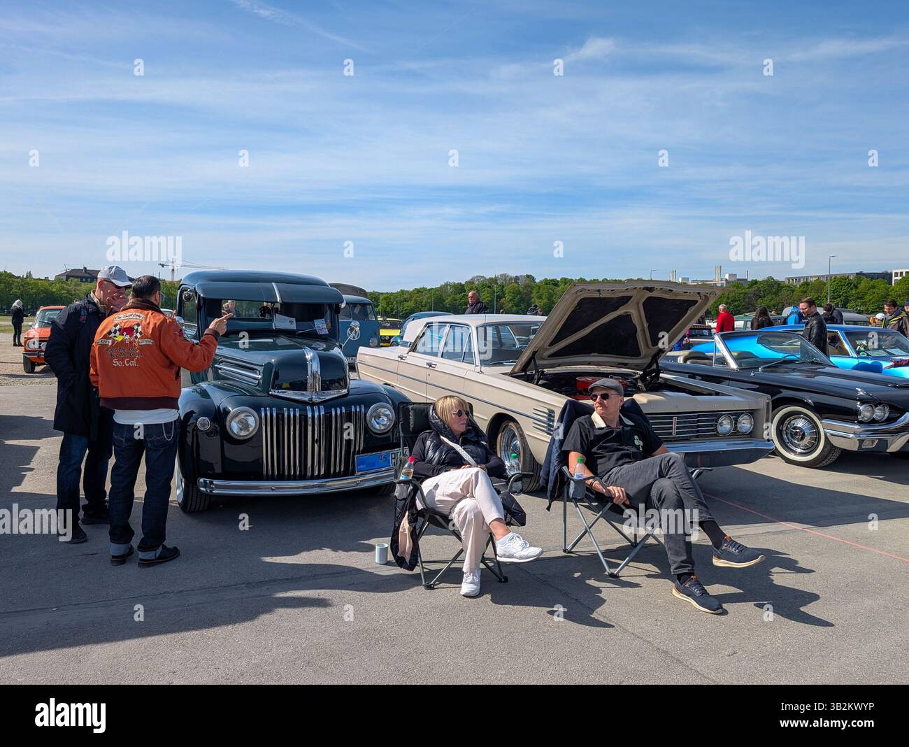 A vintage Ford pickup truck and a classic American sedan are displayed ...
