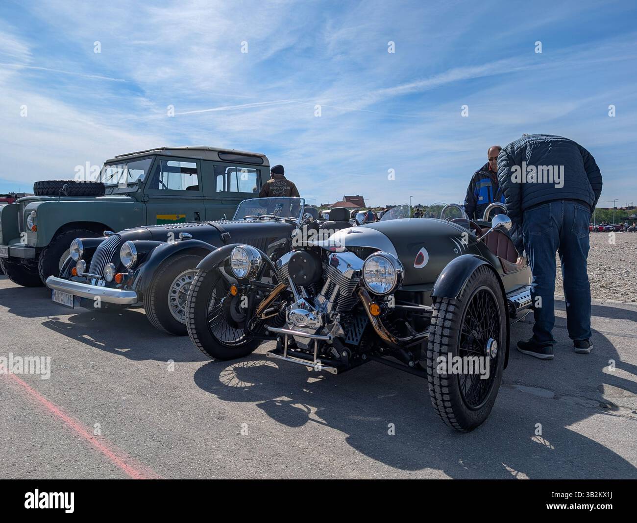 A Morgan three-wheeler, a Morgan roadster, and a classic Land Rover are ...