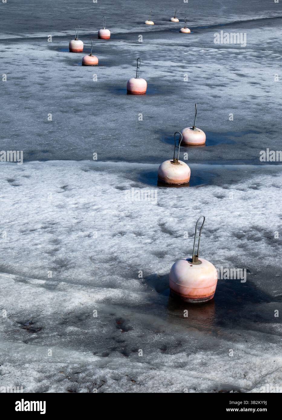 mooring buoys in harbor with melting ice Stock Photo - Alamy