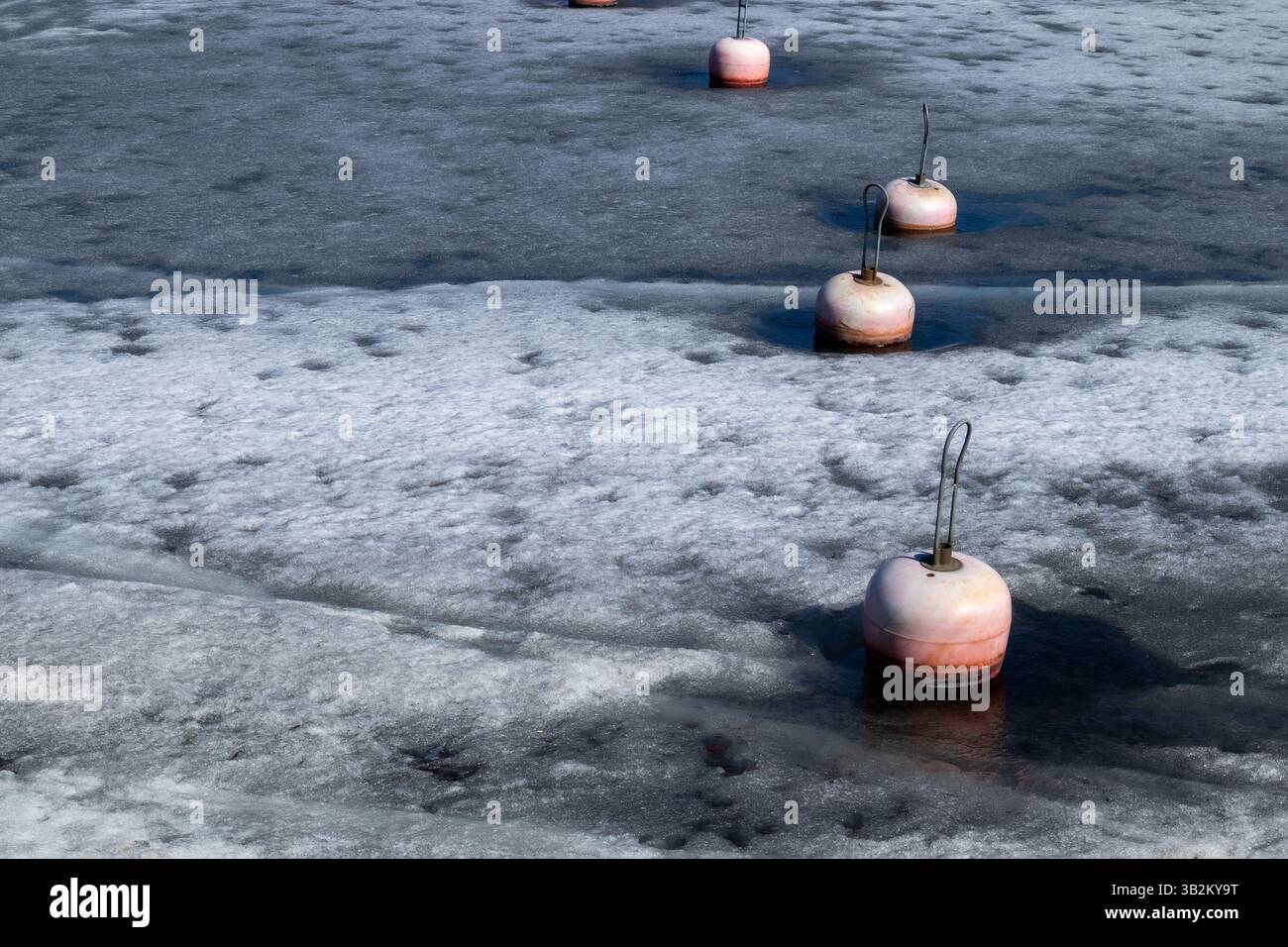 mooring buoys in harbor with melting ice Stock Photo - Alamy
