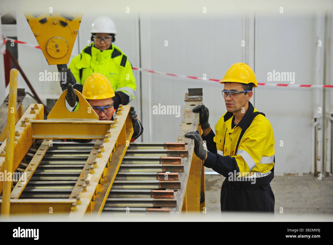 Workers fix and prepare layers of cathode copper at the plant Stock ...