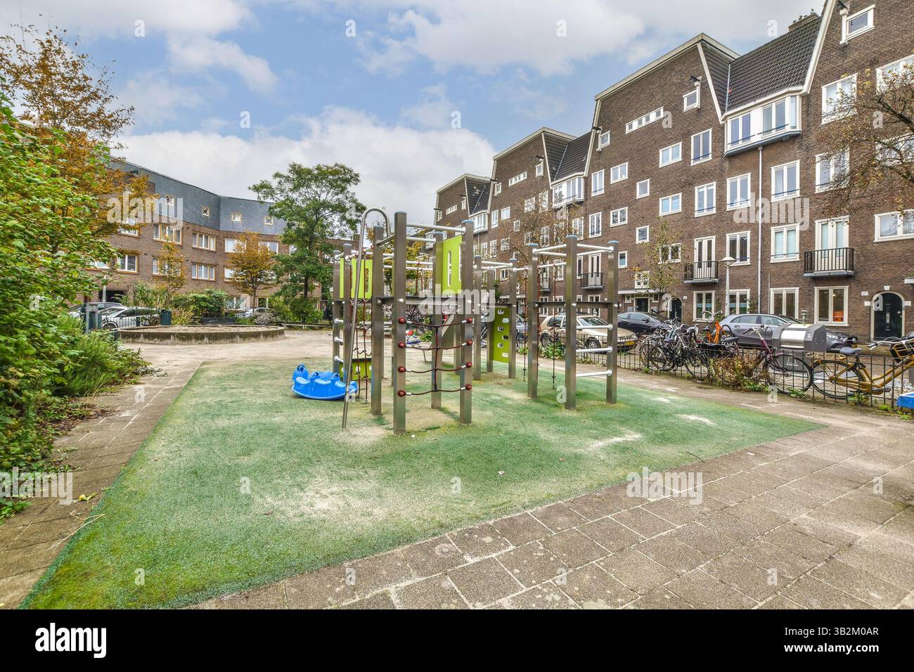 A vibrant playground features various structures amid residential ...